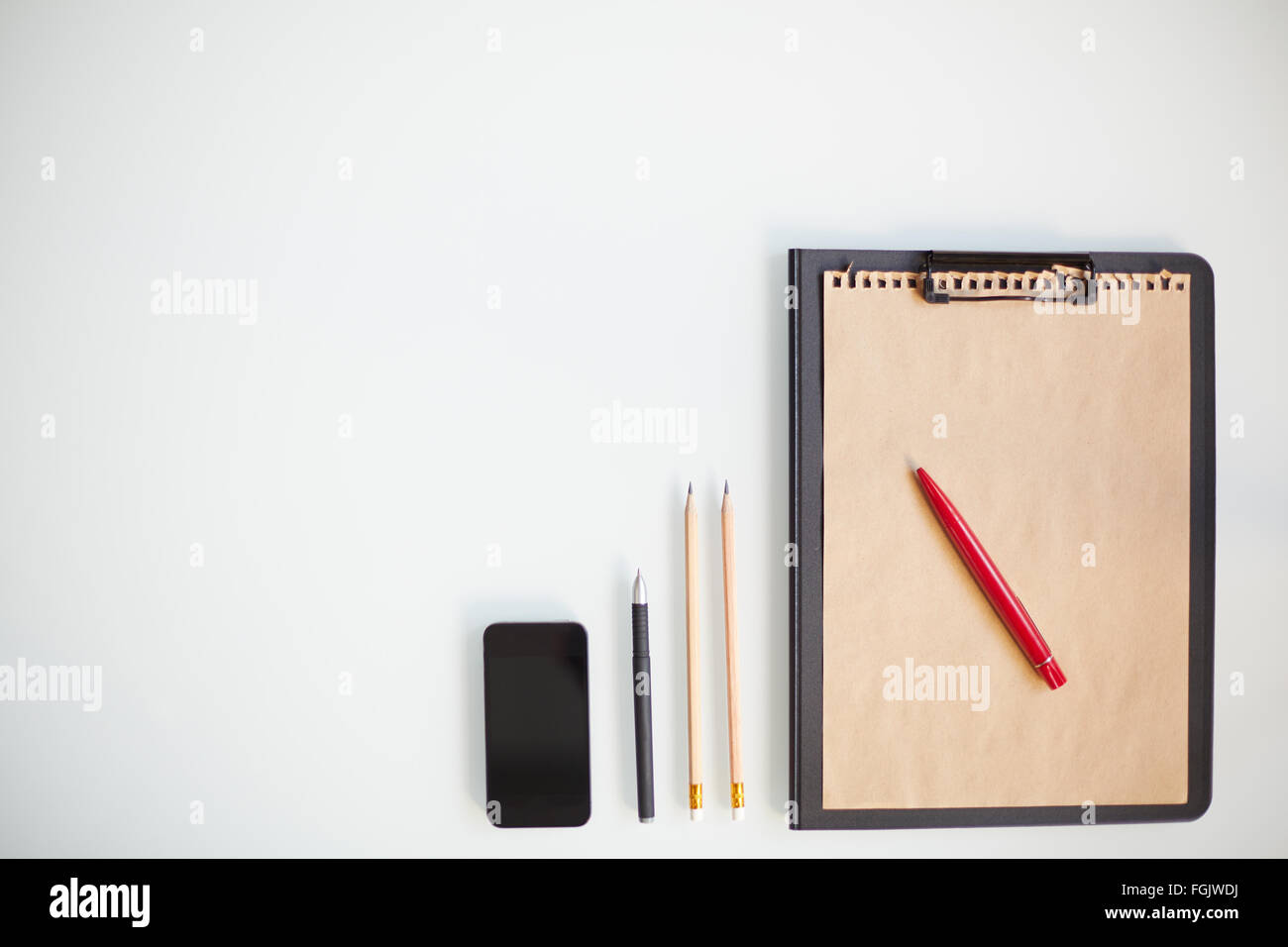 Cellphone, clipboard with notepad page, two pencils and pens Stock ...