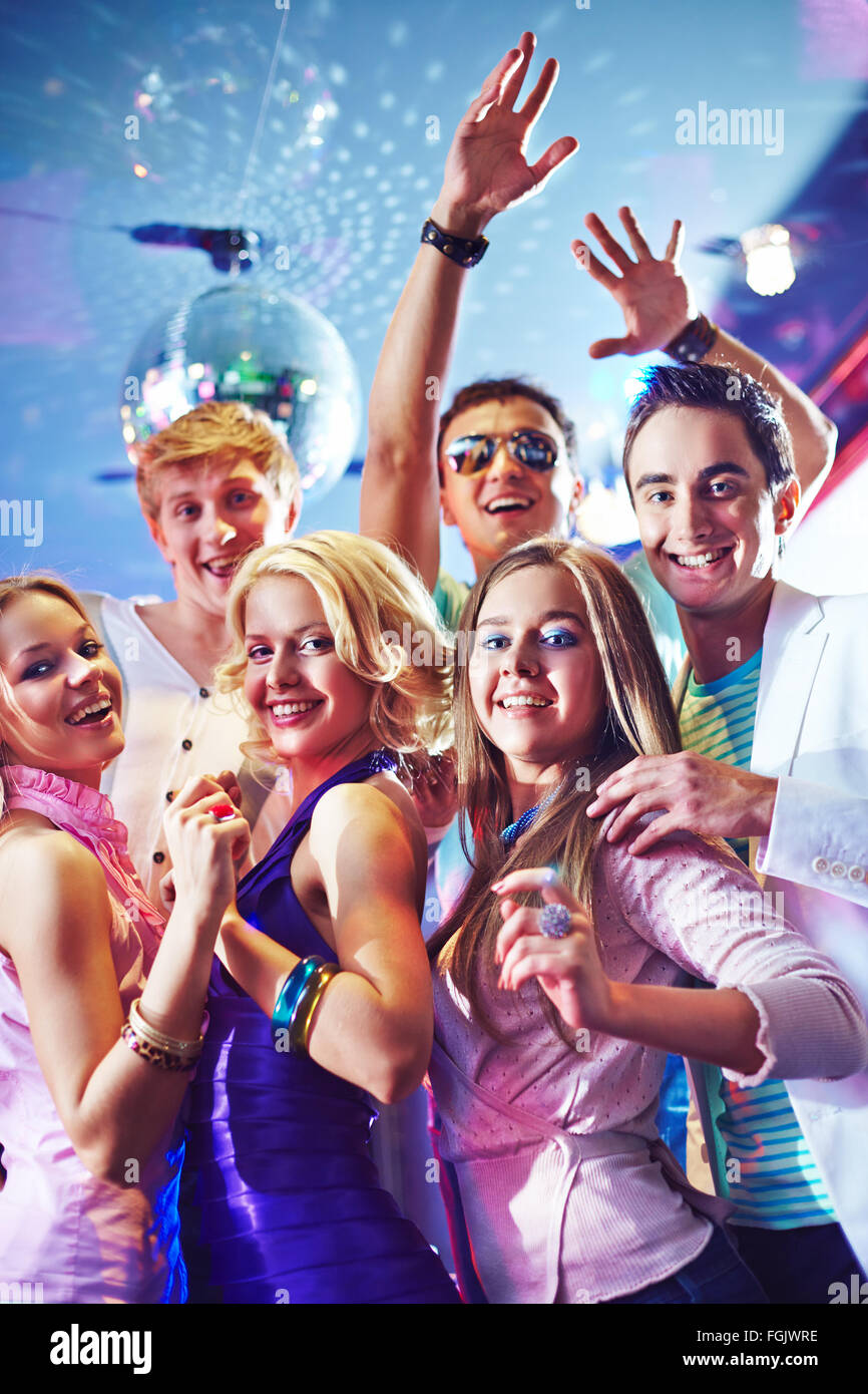 Happy young clubbers dancing at party Stock Photo - Alamy