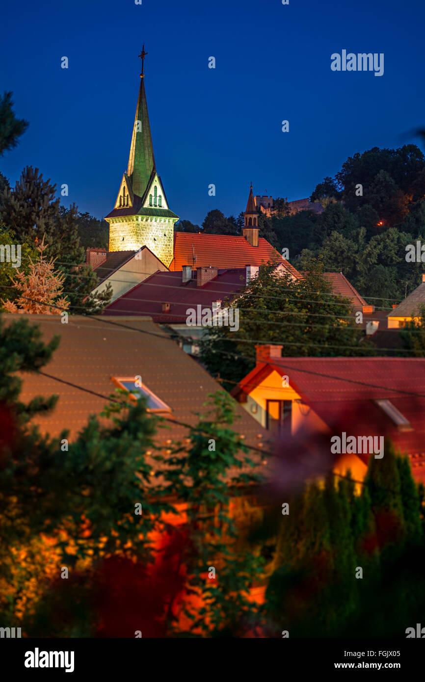 Night view on roofs and illuminated church Stock Photo - Alamy