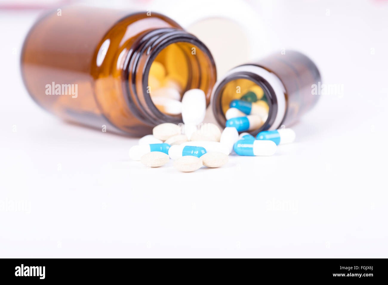 Colored pills and tablets on white background Stock Photo - Alamy