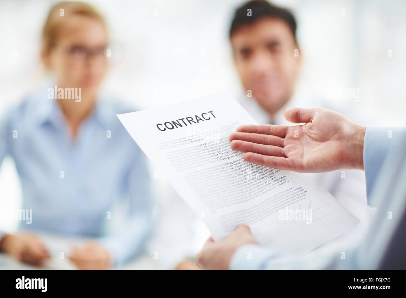 Employee pointing at contract in his hand Stock Photo - Alamy