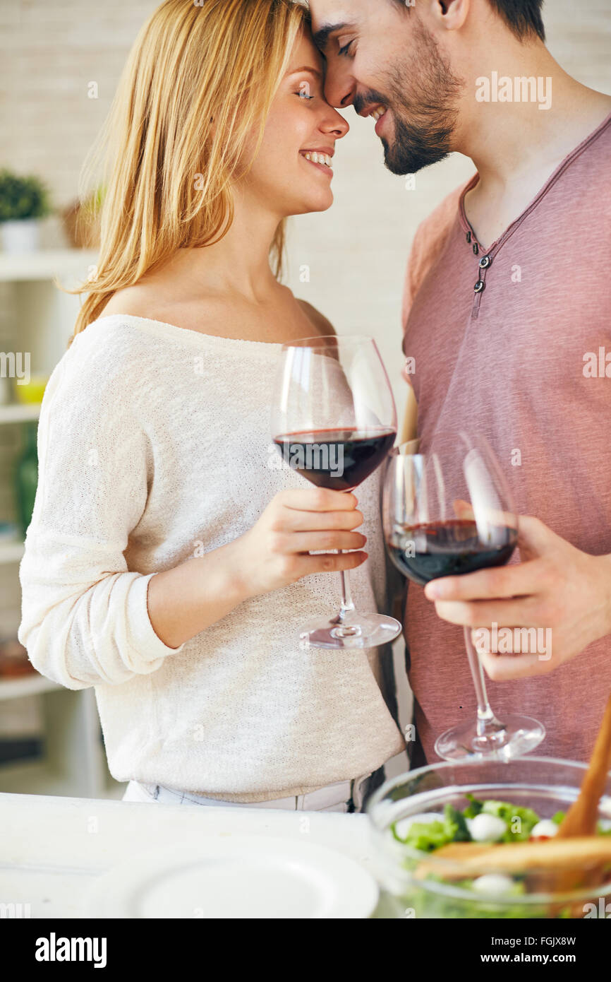Happy couple toasting with red wine Stock Photo - Alamy