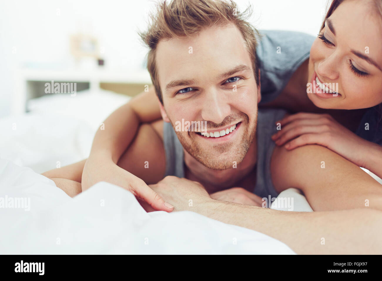 Young man lying in bed hi-res stock photography and images - Alamy