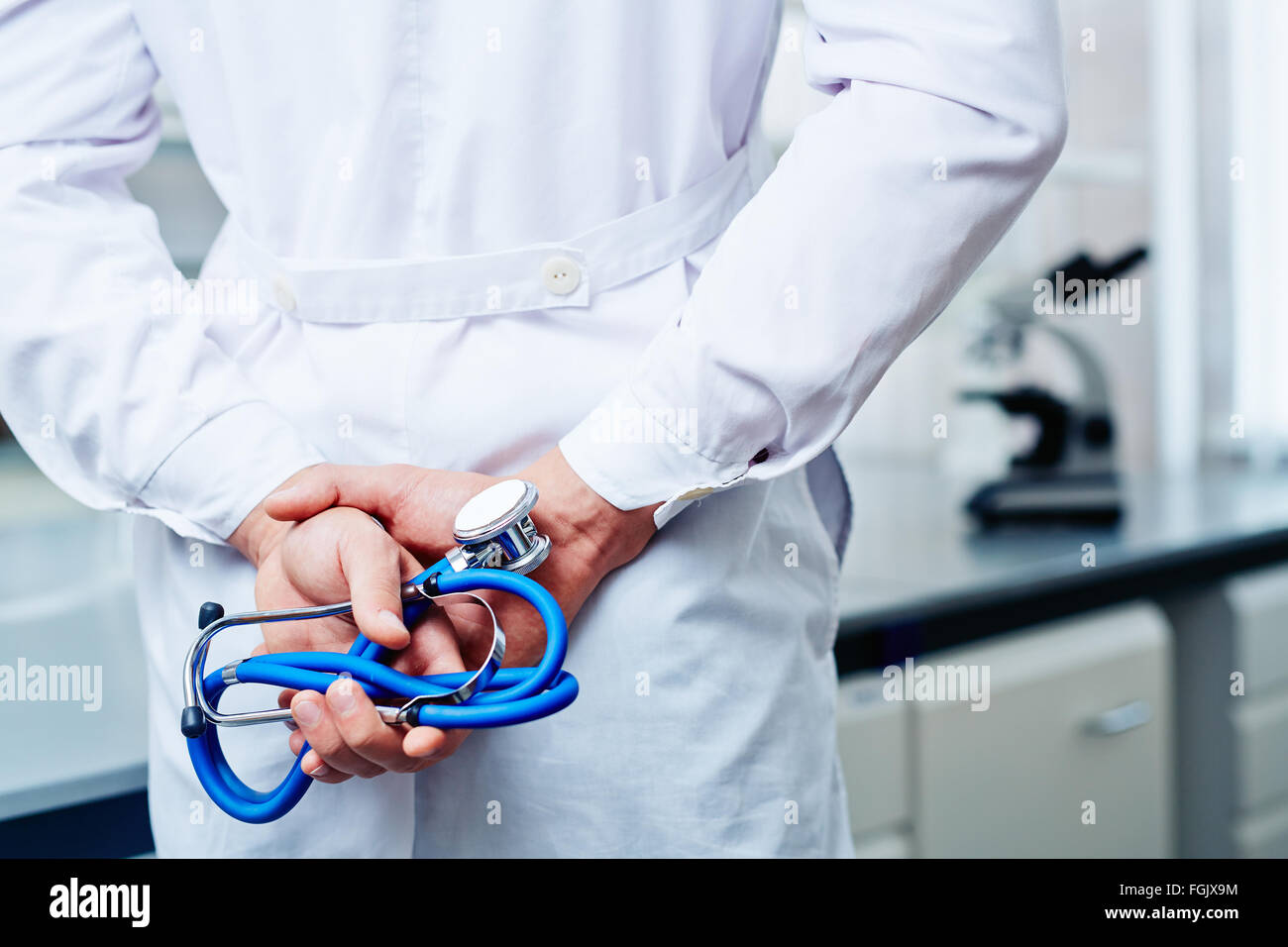 Rear view of clinician holding stethoscope Stock Photo - Alamy