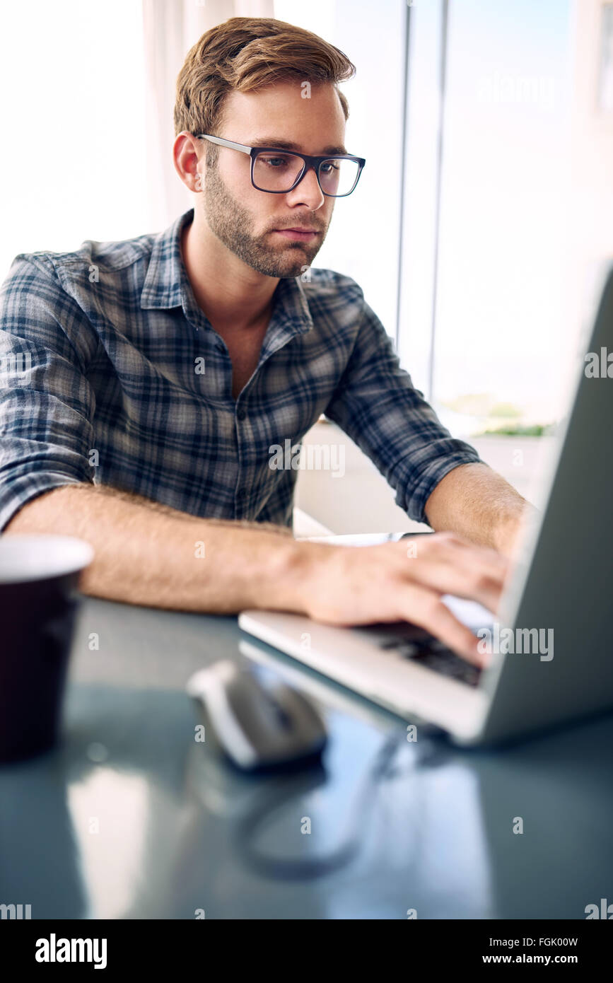 Student busy writing an article on his notebook Stock Photo - Alamy