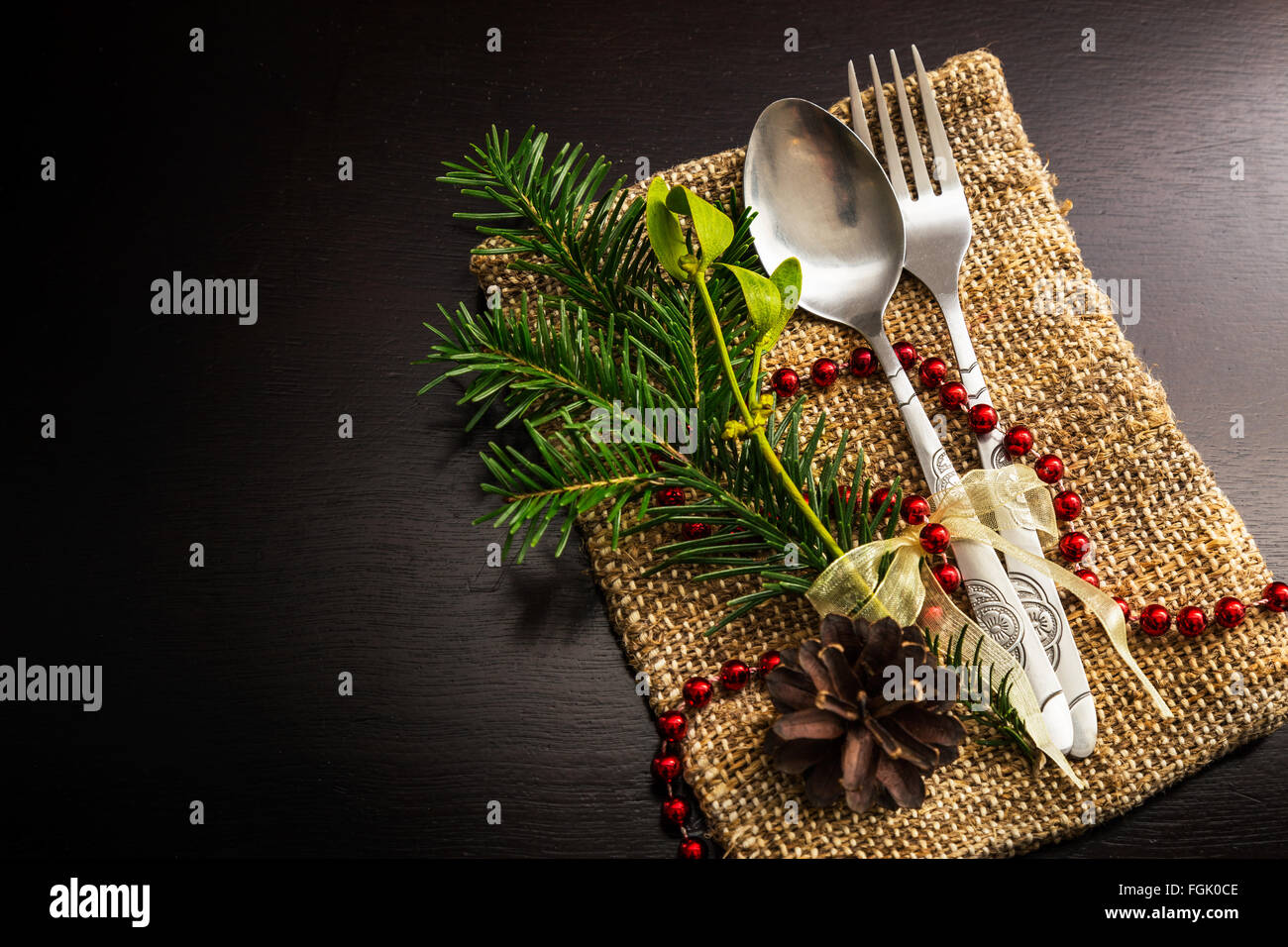 Christmas silverware at dark wooden table Stock Photo - Alamy