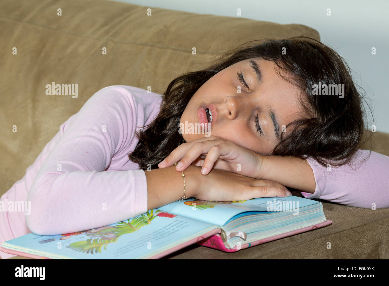 Girl sleeping over books Stock Photo - Alamy