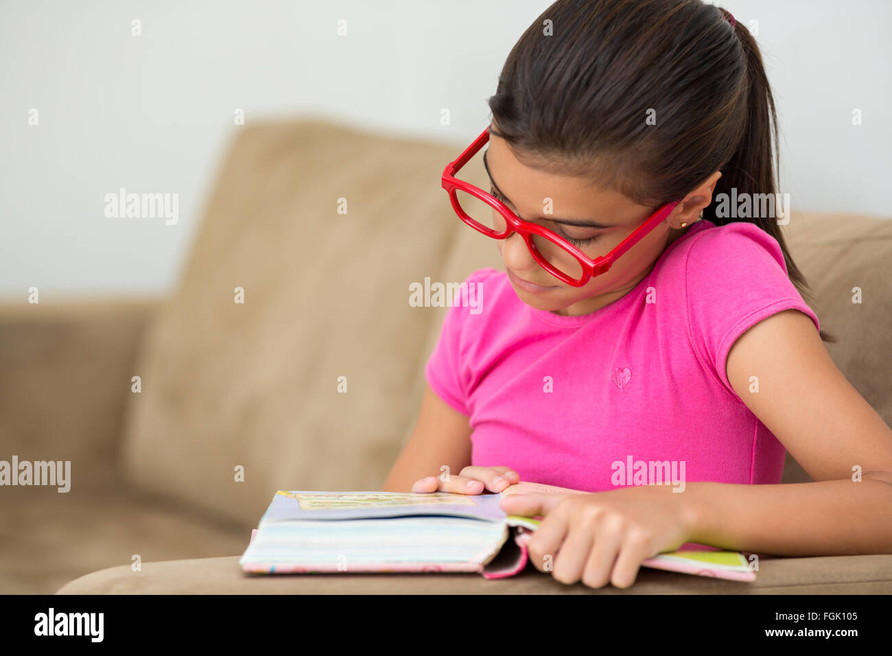 Young girl reading concentrated Stock Photo - Alamy