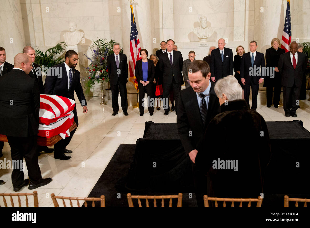 As his widow Maureen Scalia is helped to her place at front, the casket ...