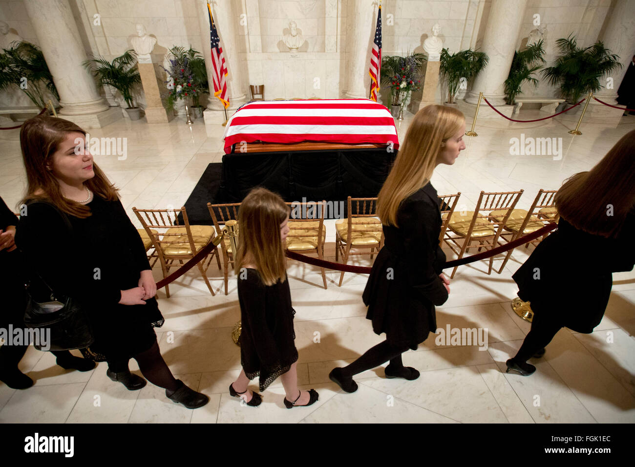 Relatives pass the casket as they leave a private ceremony in the Great ...
