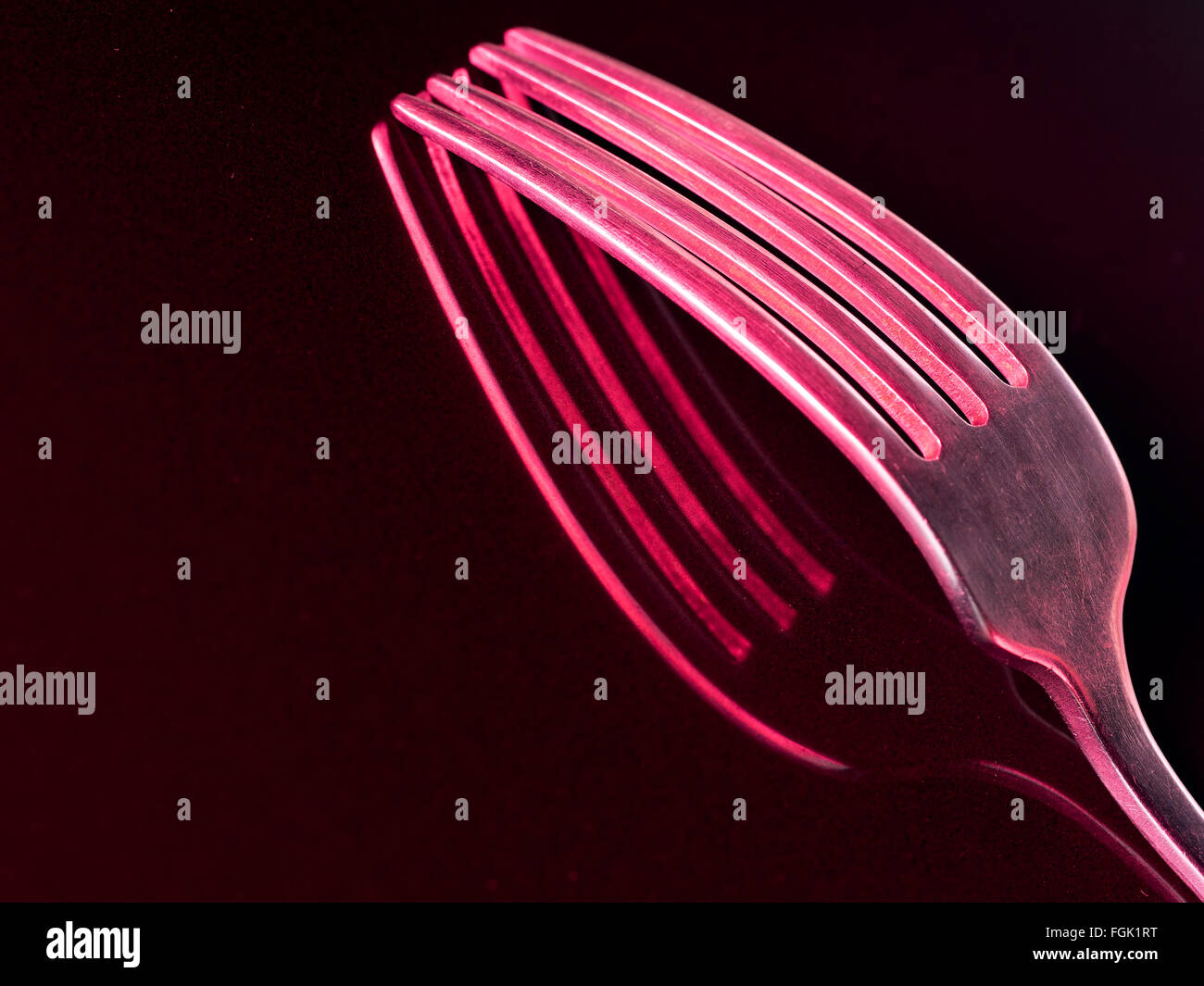 Pink fork reflection, food background. Red light Stock Photo - Alamy