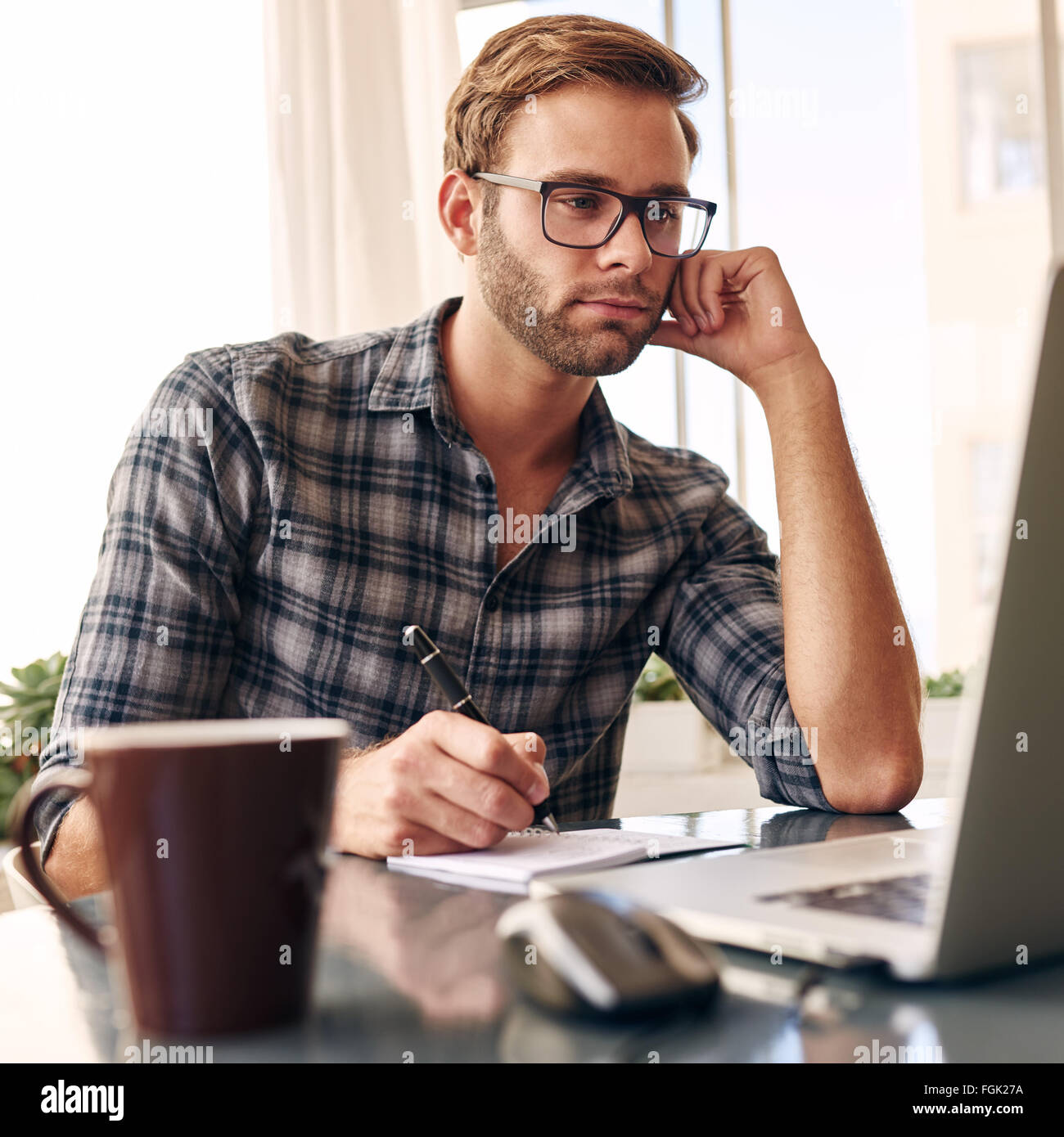 Young student studying taking notes laptop hi-res stock photography and ...