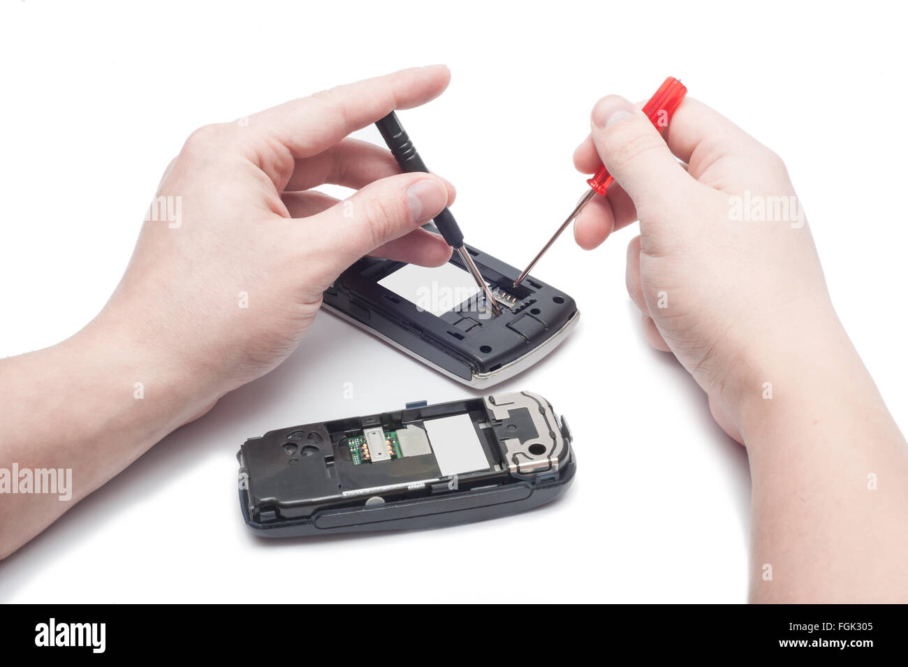 Close-up Of Human Hand Repairing Cellphone With Screwdriver isolated on ...