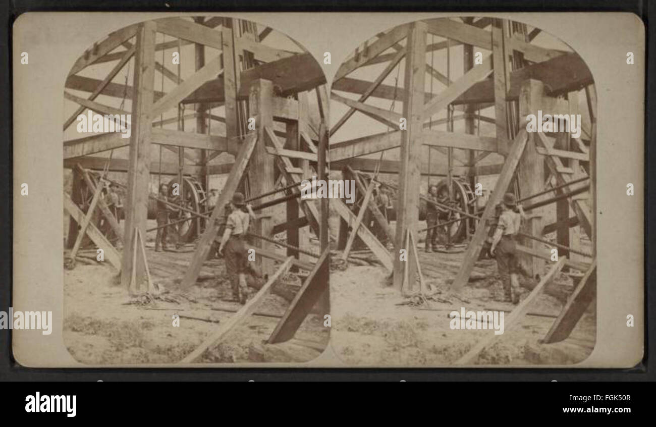 A stereoscopic photograph showing workers drilling an oil well ...