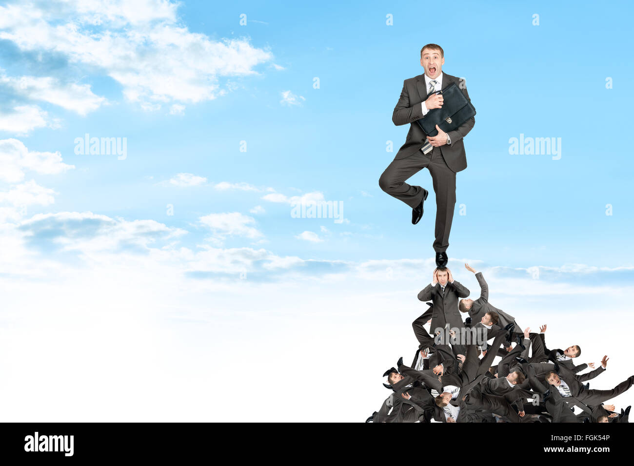 Businessman on pile of people Stock Photo - Alamy