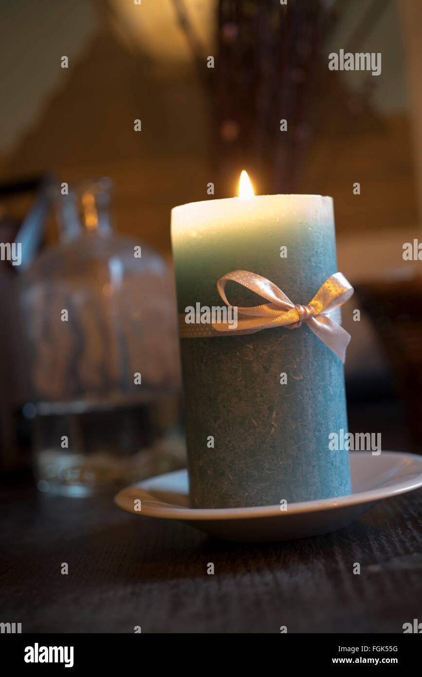Candle on a kitchen table Stock Photo - Alamy