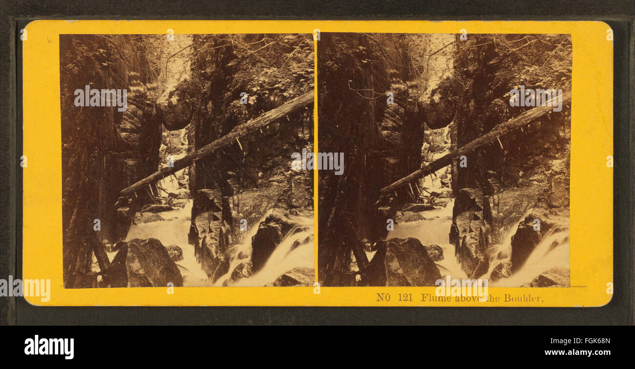 This image shows a flume above a boulder, capturing the natural water ...