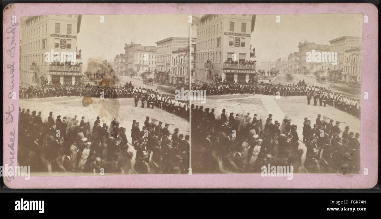 A photograph by William E. James showing a view of Genesee Street, with ...