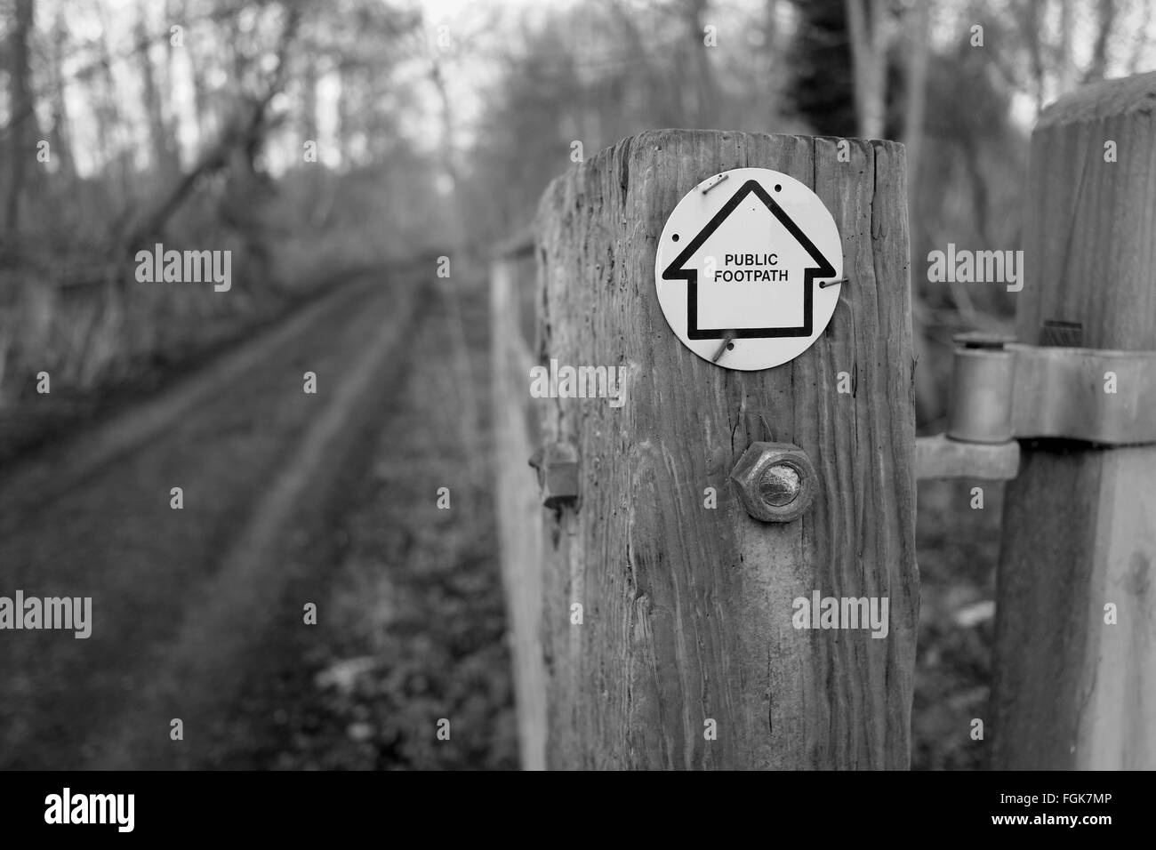 Public footpath sign on a rural farm track gate post, February 2016 ...