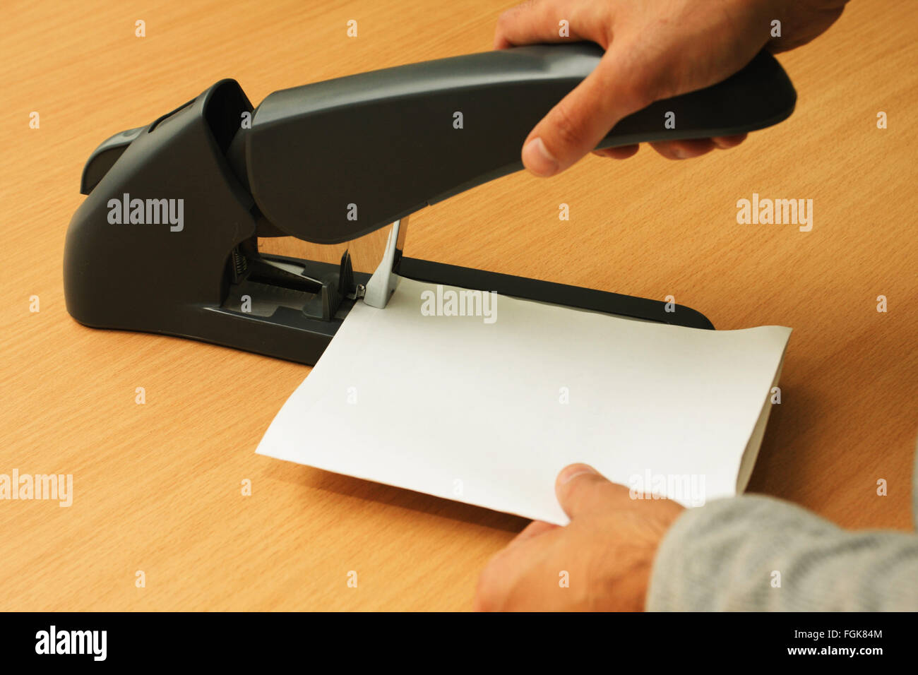 binding papers with stapler by both hands Stock Photo - Alamy