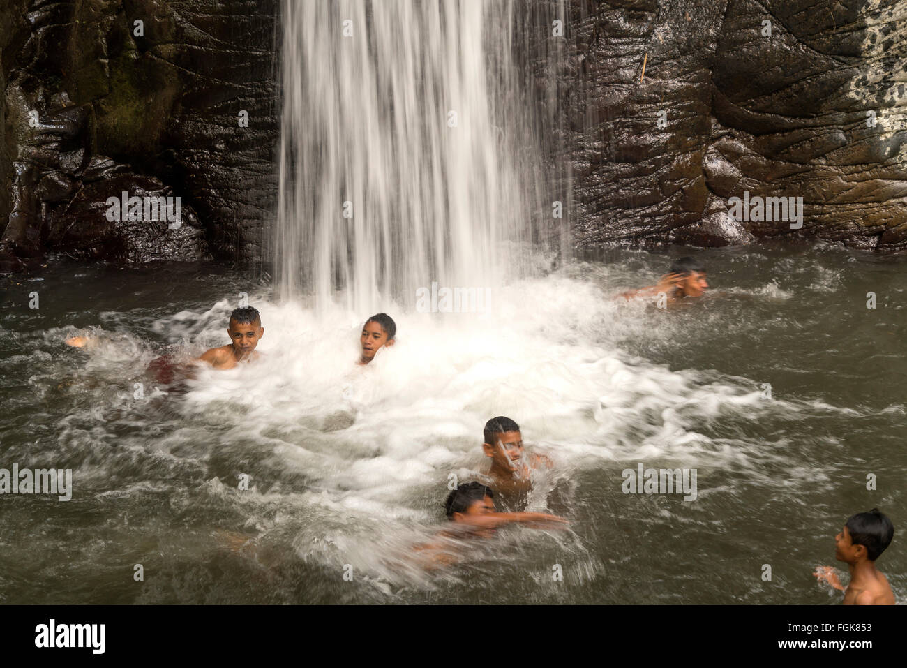 children playing in the waterfall in Moni, Flores, Indonesia, Asia ...