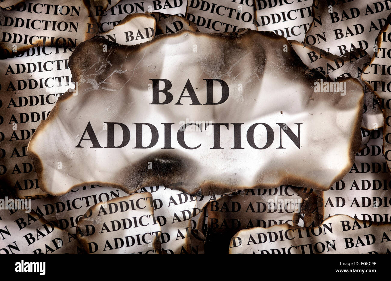 Burnt Bad Addiction. Burnt pieces of paper with the words "Bad ...