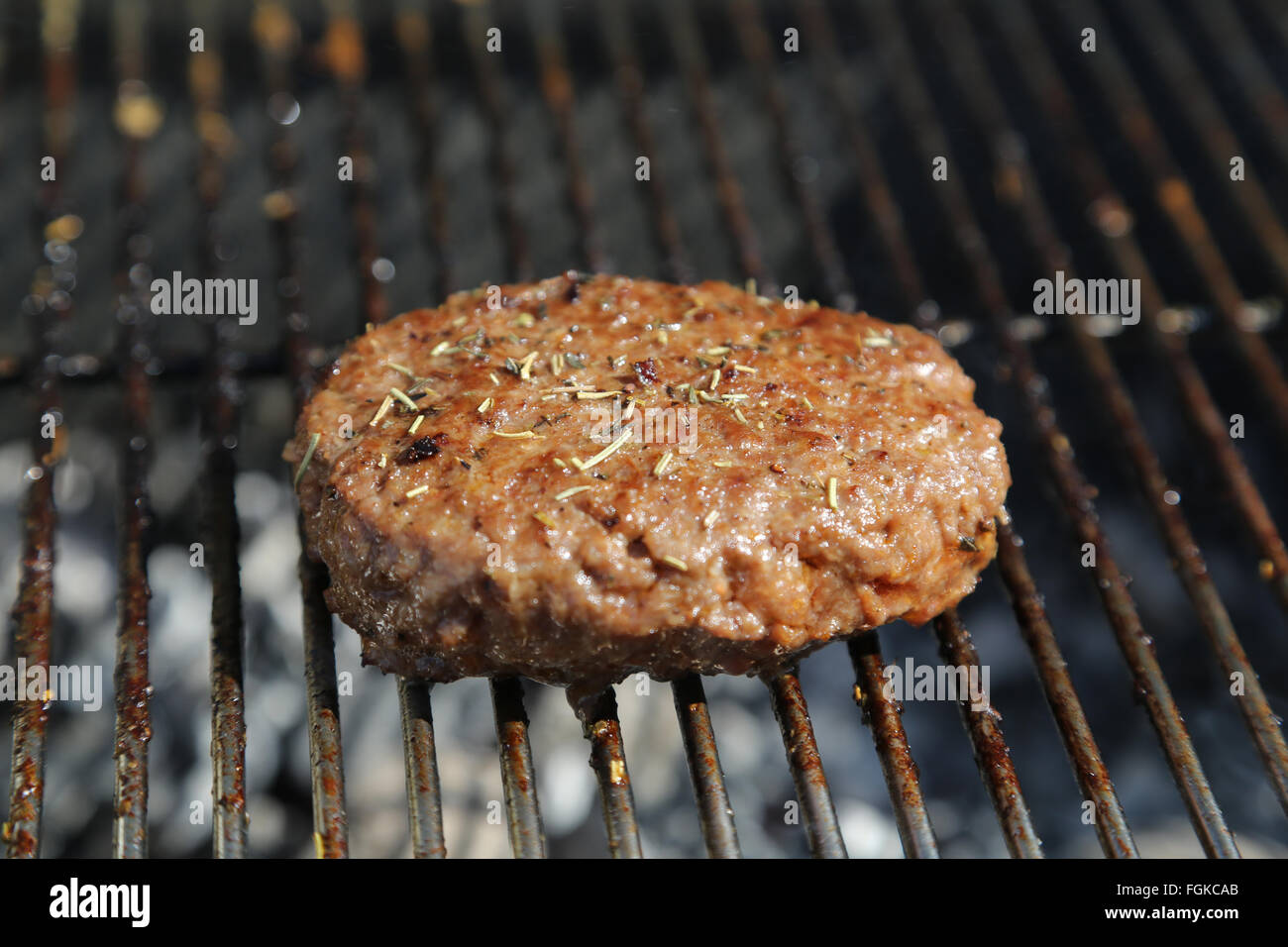 Cooking a Meat on a Barbecue outside in the garden Stock Photo - Alamy