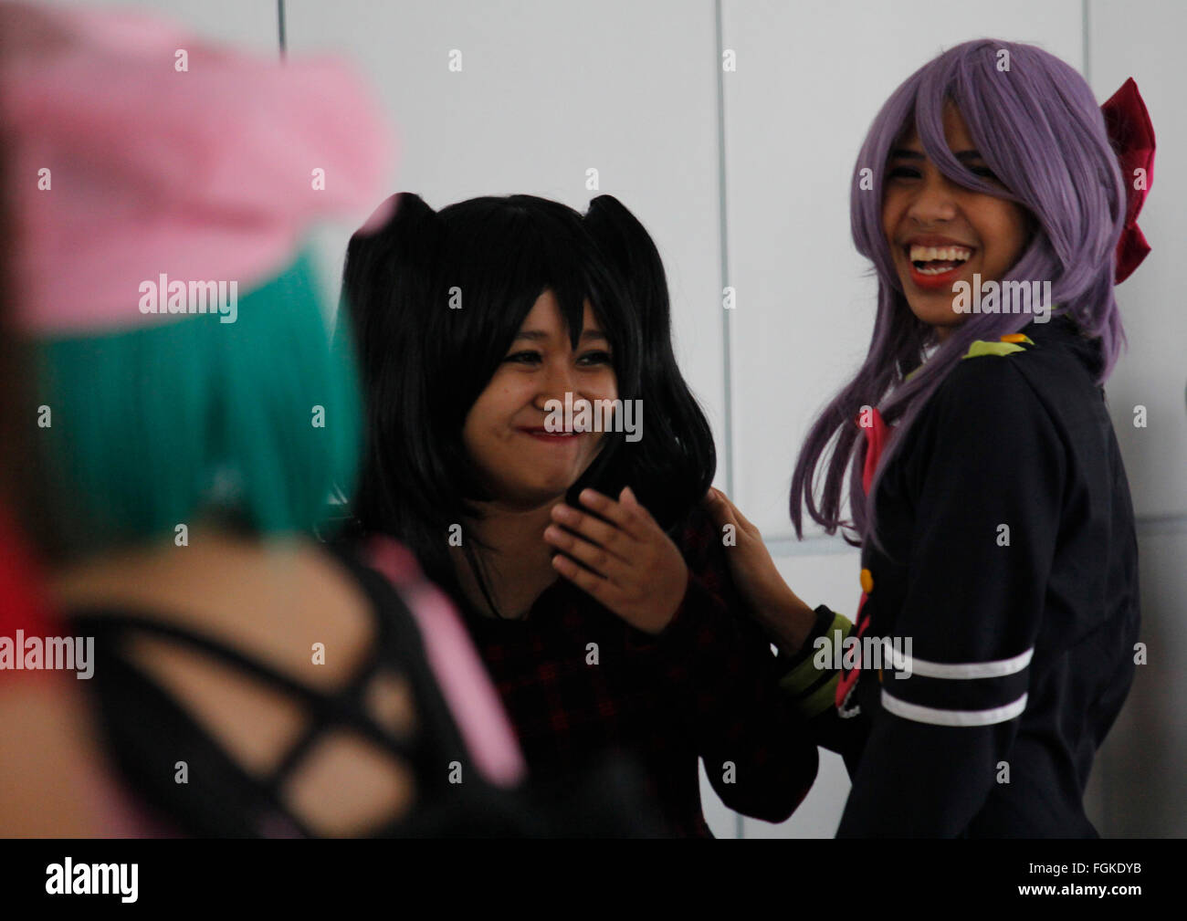 Pasay City, Philippines. 20th Feb, 2016. Cosplayers react as they wait ...