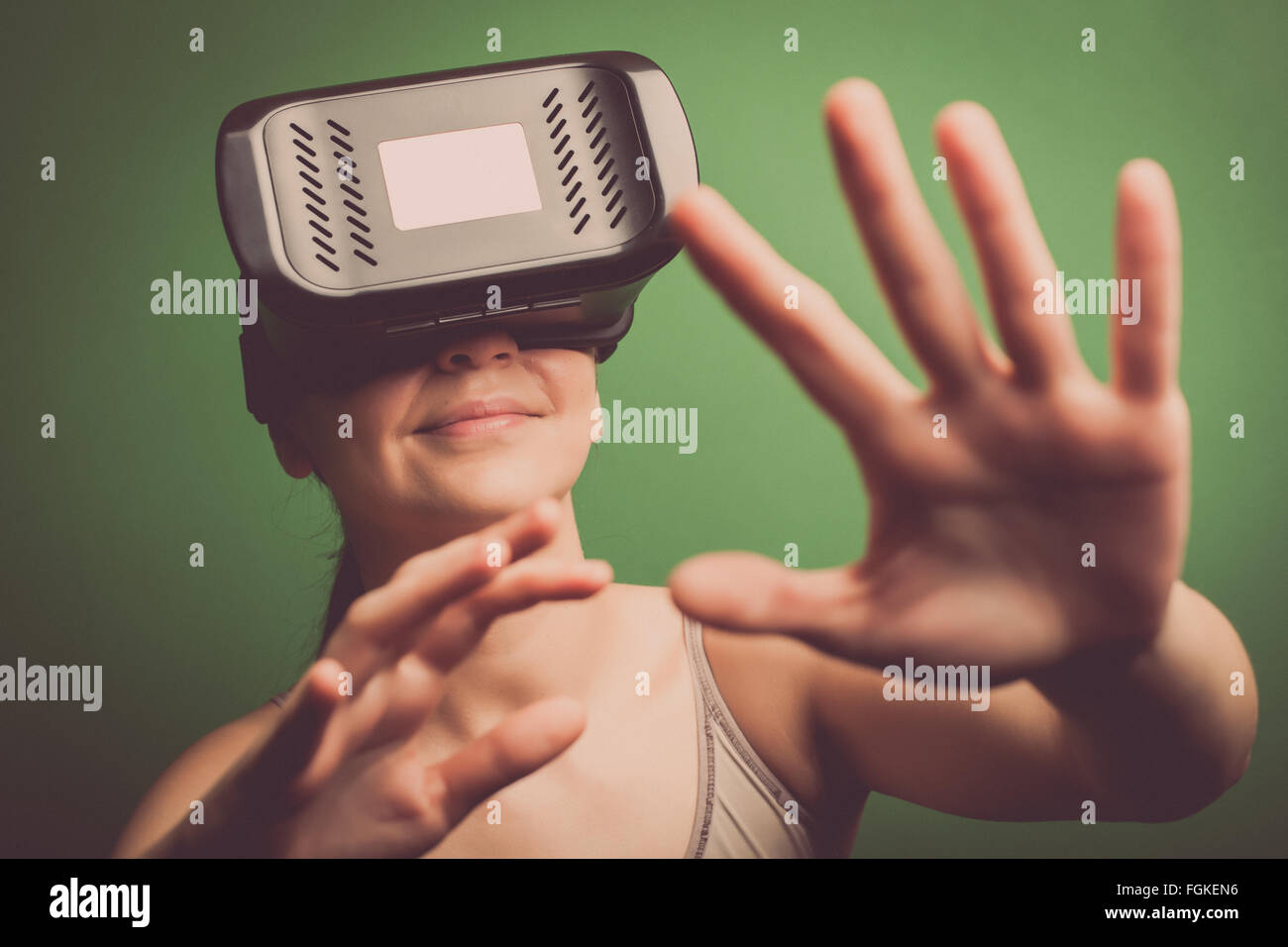 Color shot of a young woman looking through some VR glasses, a device ...