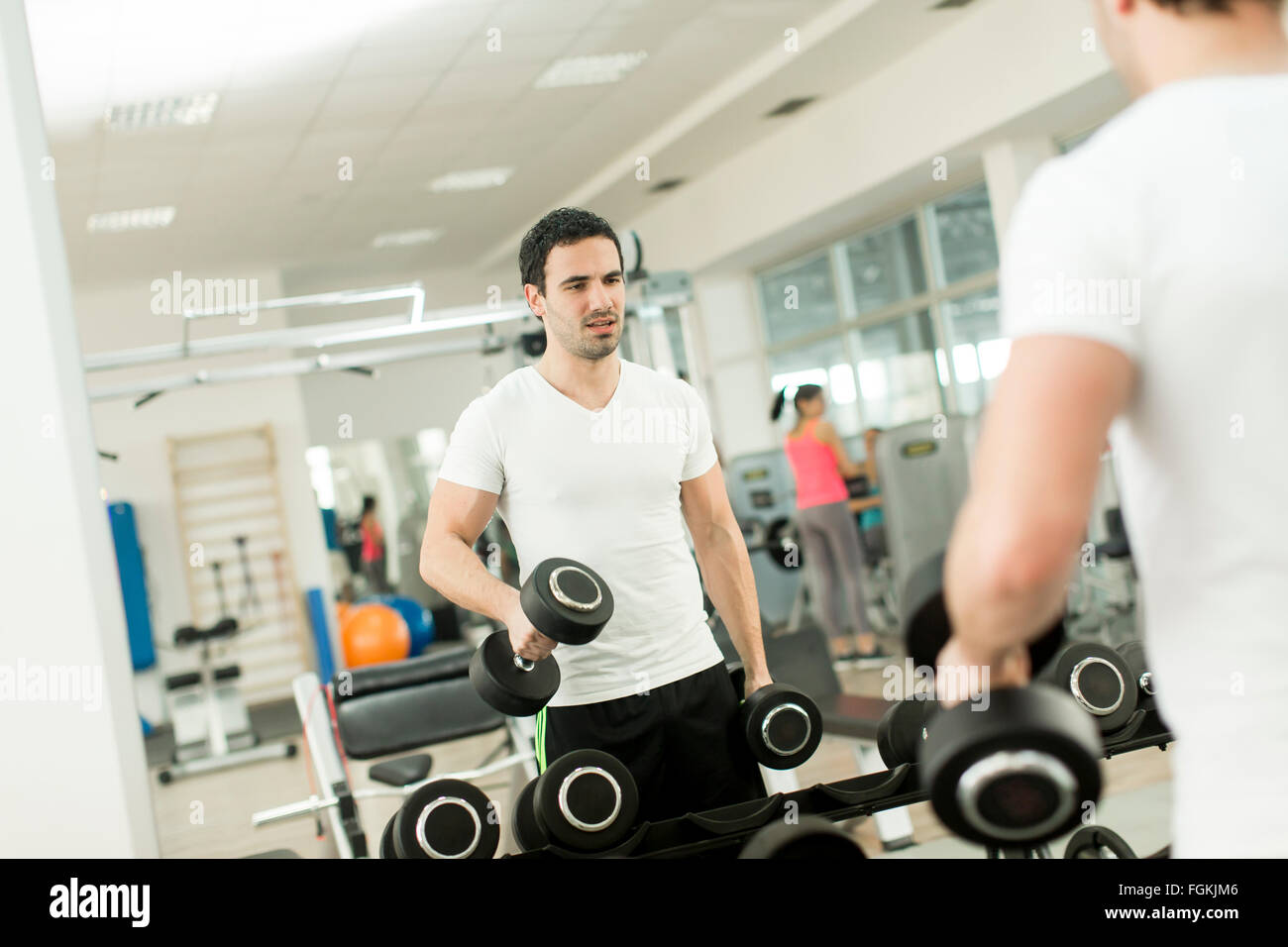 Young man training in the gym Stock Photo - Alamy