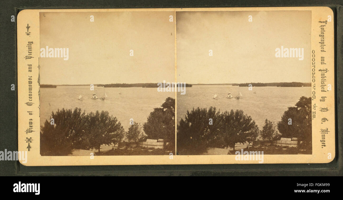 A historic photograph by D. G. Munger depicting a tranquil lake with a ...