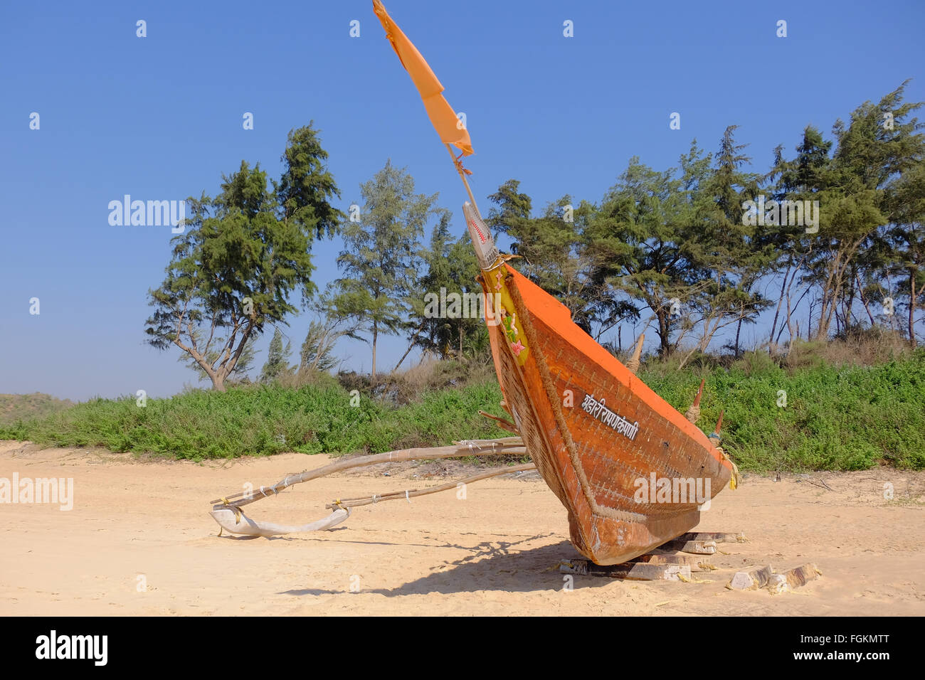 Traditional wooden fishing boats on a beach in Maharashtra state ...
