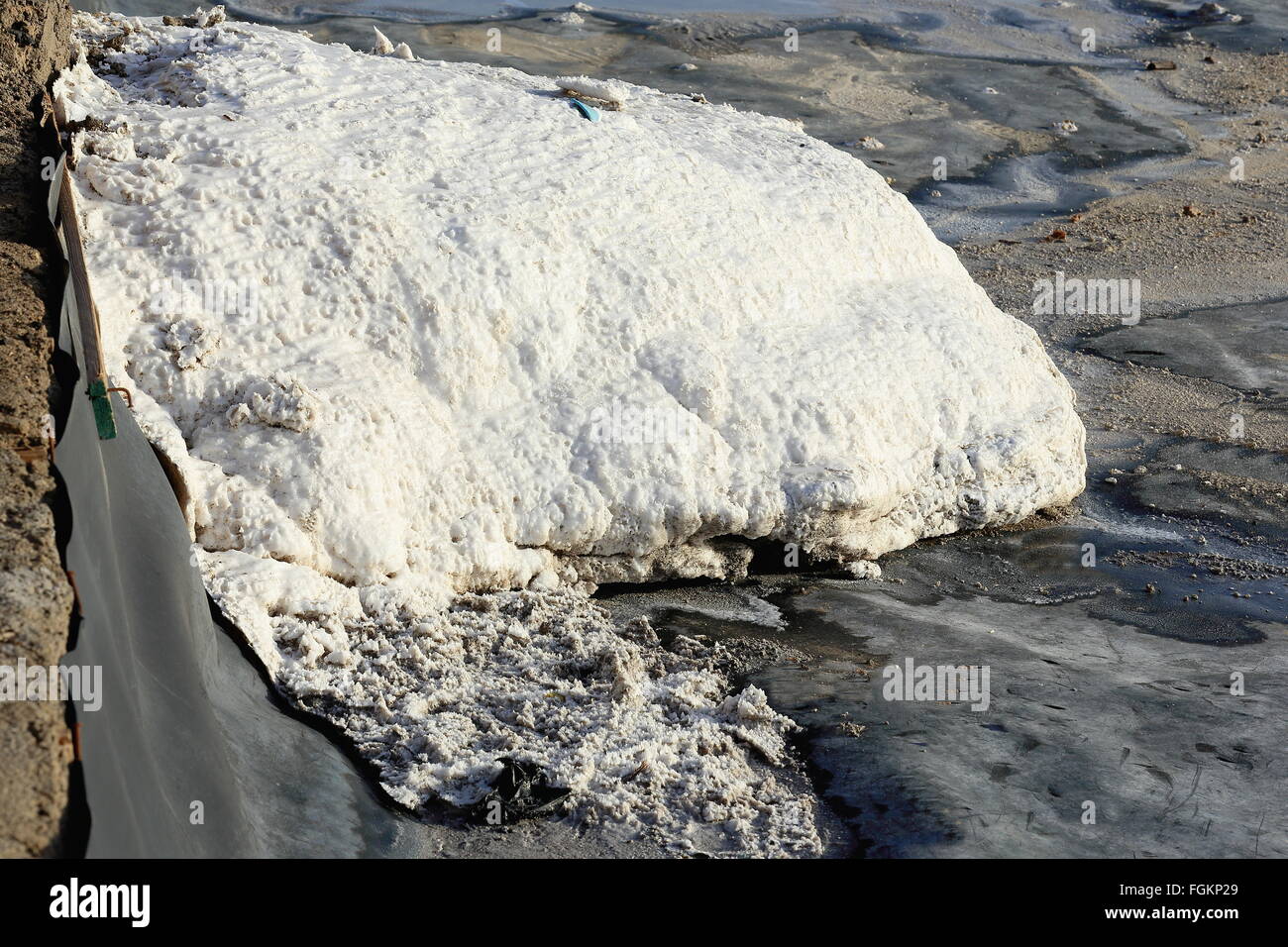 Salt block-artificial pool for water evaporation-salt mounds beside the ...