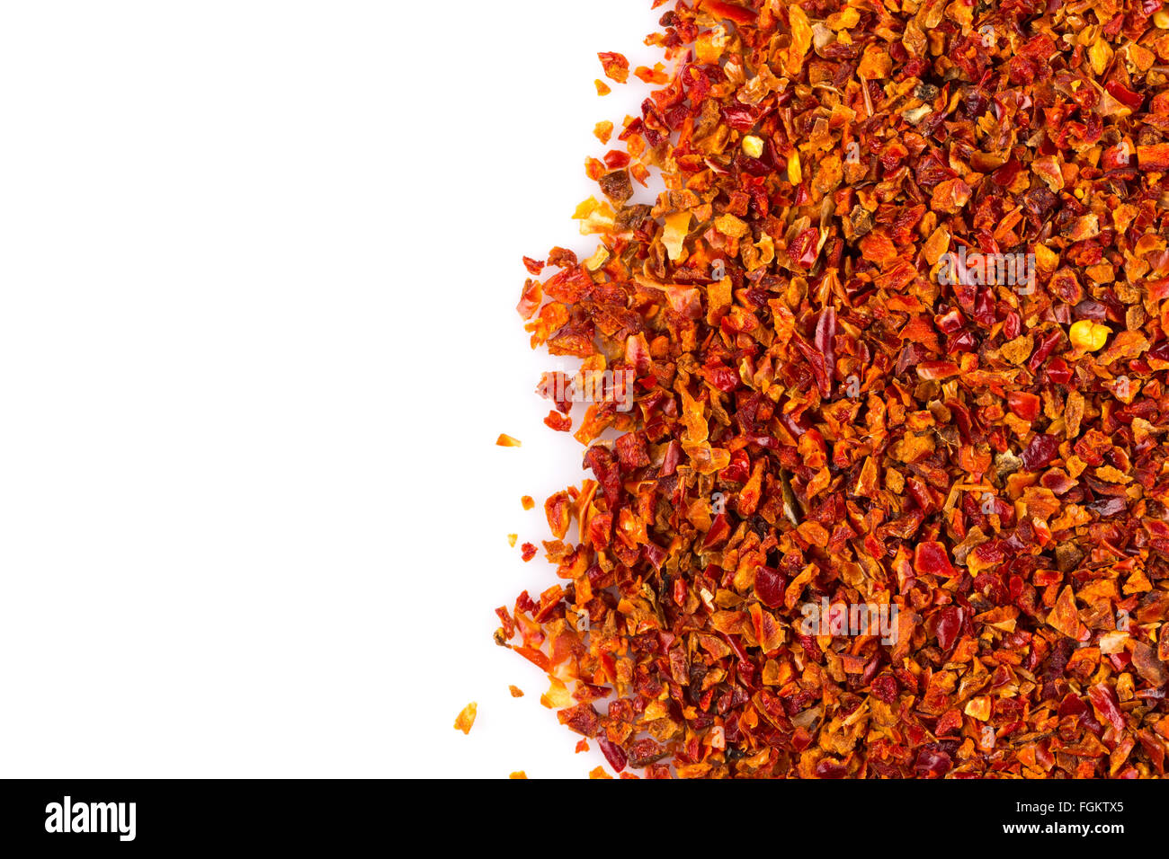 Crushed red chili pepper on white background Stock Photo - Alamy