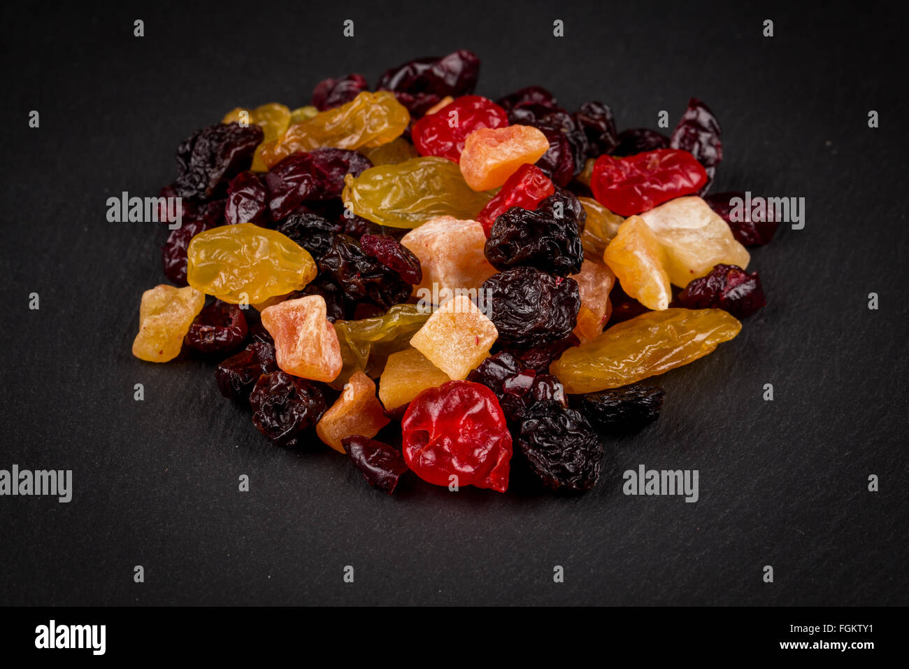 Mix variety of dried fruiton black dark stone background Stock Photo ...