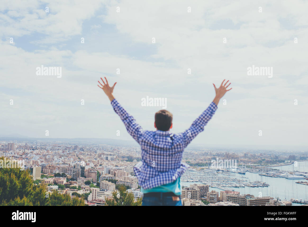 Back view of young man raising hands Stock Photo - Alamy