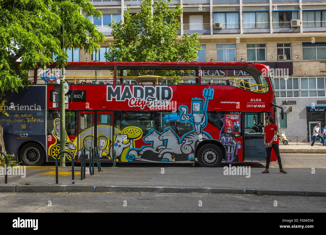 View of a touristic red bus in a street of Madrid city, Spain Stock ...