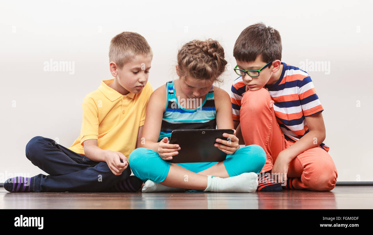 Children playing on tablet. Having fun and learning Stock Photo - Alamy