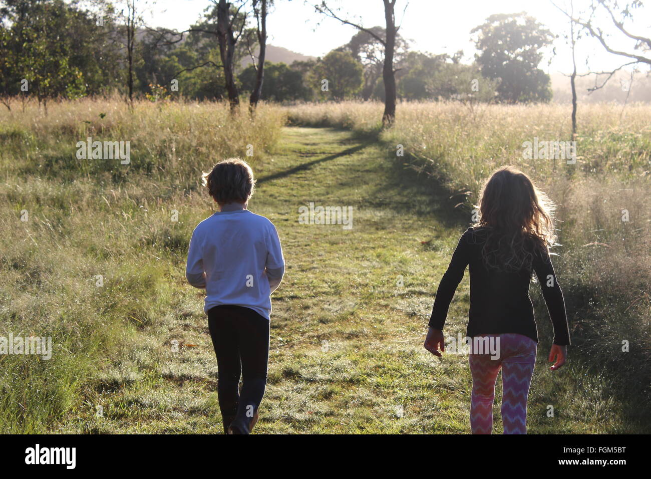Boy and Girl walking in the countryside in the morning Stock Photo - Alamy