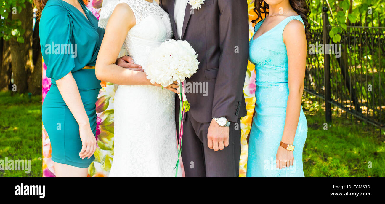 Handsome groom in suit hugging elegant bride with bridesmaids Stock ...