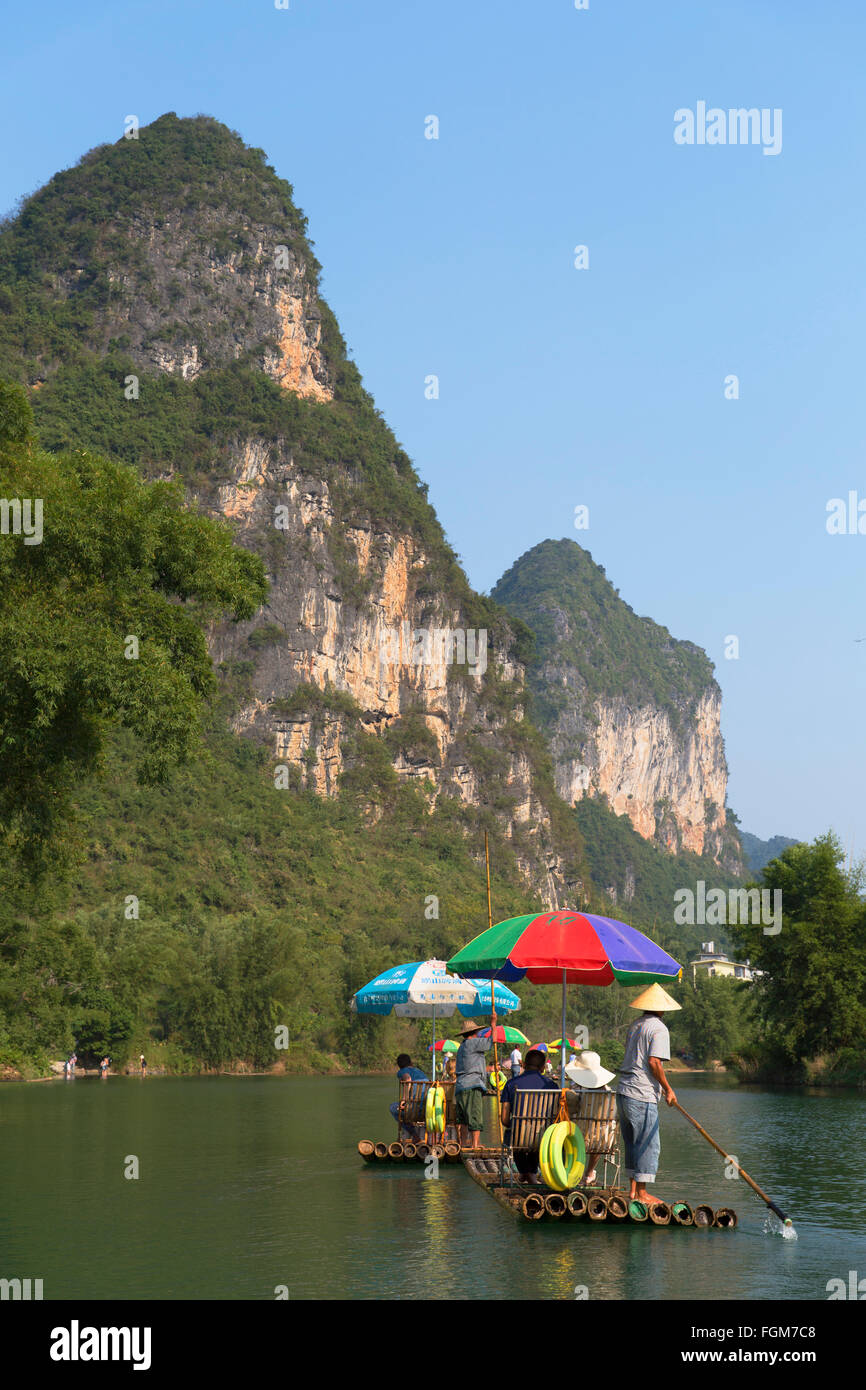 People taking bamboo raft along Yulong River, Yangshuo, Guangxi, China ...