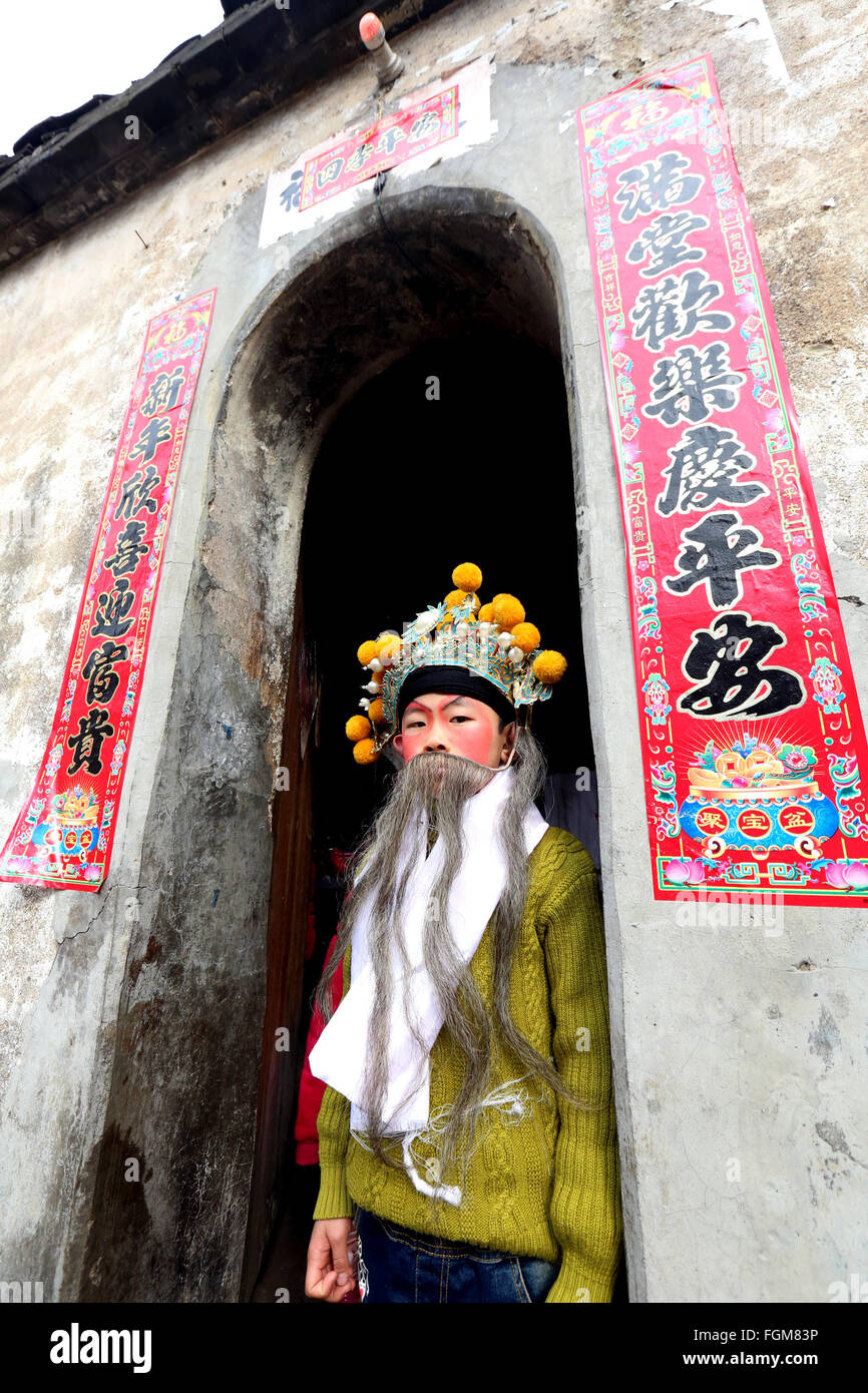Liancheng. 21st Feb, 2016. A boy dressed as an ancient official waits ...