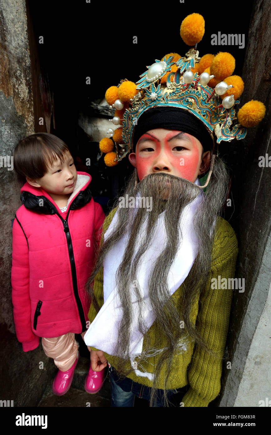 Liancheng. 21st Feb, 2016. A boy (R) dressed as an ancient official ...