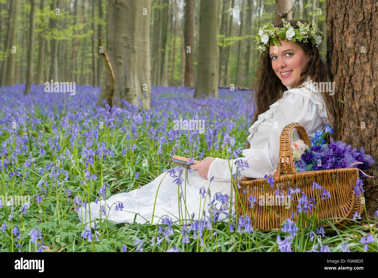 Victorian woman in white dress in a springtime bluebells forest Stock ...