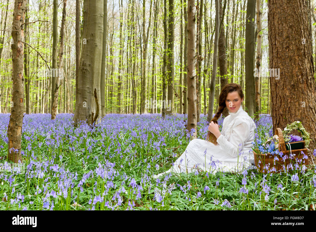 Victorian woman in white dress in a springtime bluebells forest Stock ...