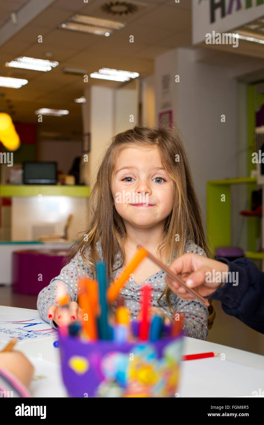 Little girl drawing at playroom Stock Photo - Alamy