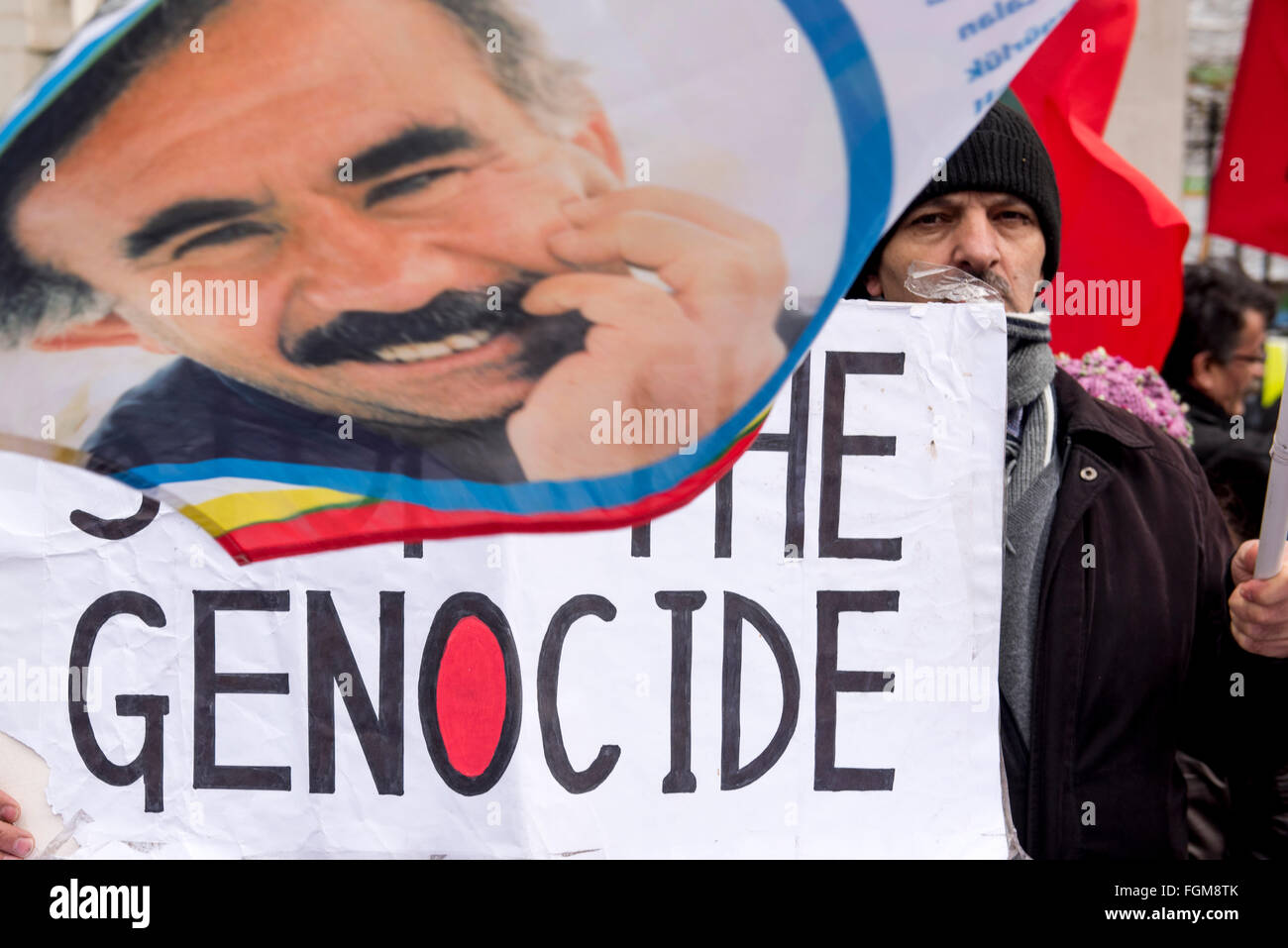 Placard - 'Stop The Genocide' next to the flag with portrait of Kurds ...