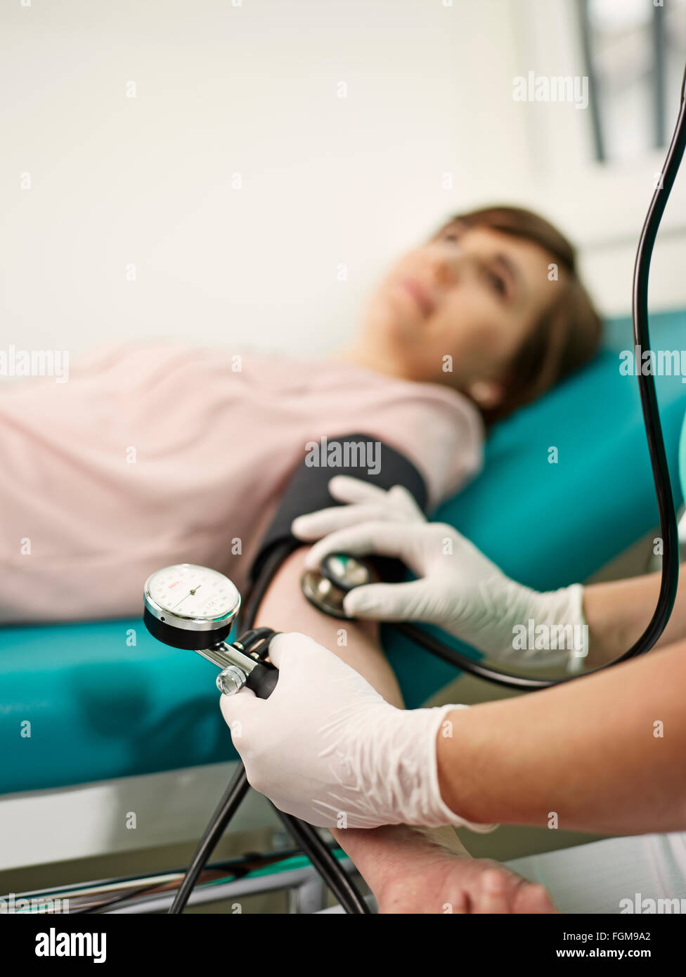 Nurse measuring patient's blood pressure, Austria Stock Photo - Alamy