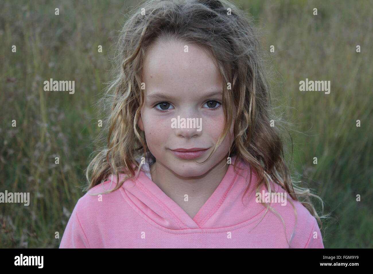 Casual and natural eight year old girl looking straight at camera Stock ...