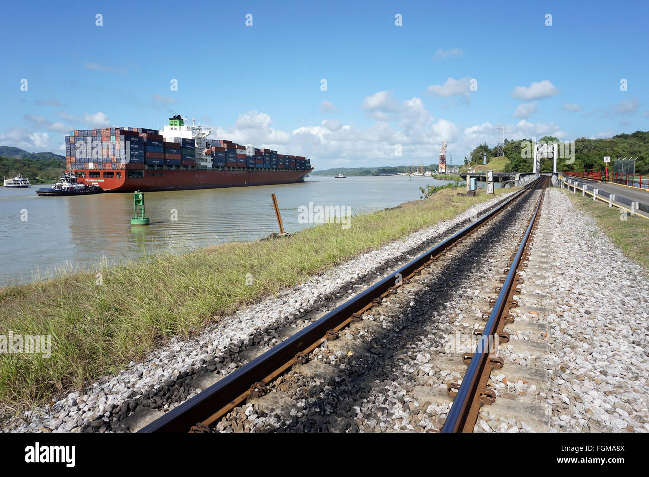 Container ship at the Panama canal and the Panama canal railway at ...
